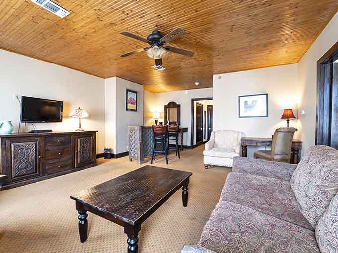 Knotty pine ceilings, warm lamps, and a sofa that's clearly seen some excellent conversations happen around it.
