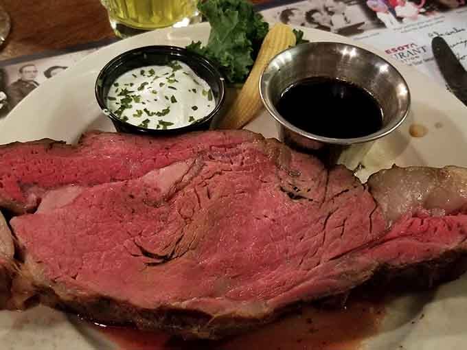 Prime rib sliced thick and cooked pink, proving that some traditions survive because they're absolutely worth keeping around forever.