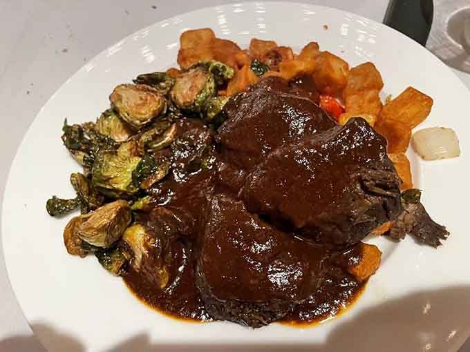 Braised beef short rib so tender it practically waves goodbye to the bone. Brussels sprouts never had it so good.