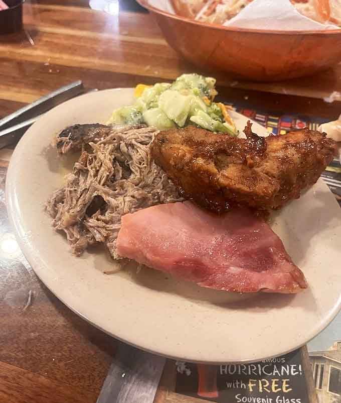 Pulled pork and ribs sharing plate space, proving this seafood palace knows its way around a smoker too.
