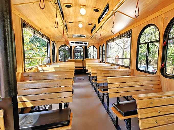 Rows of honey-colored wooden benches and arched windows make this interior feel like a rolling living room you never want to leave.