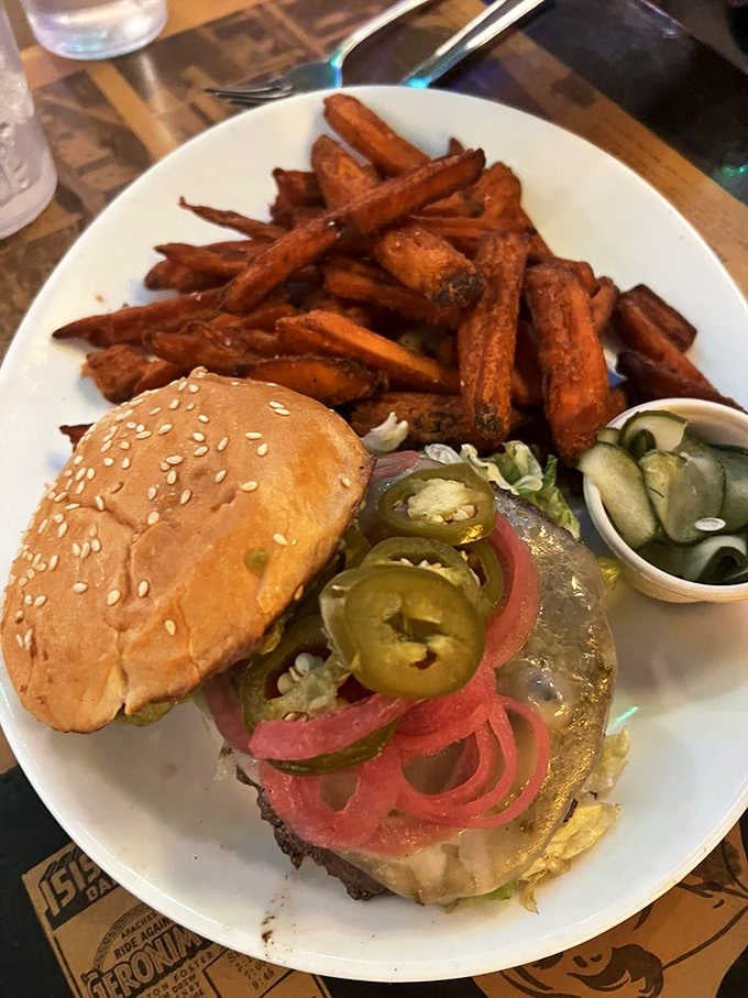 Pickled onions, jalapeños, and sweet potato fries. The Bourbon Jalapeño Burger at The Sink plays no games.