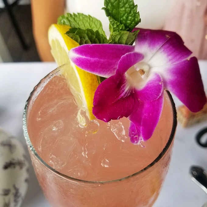 A cocktail so beautifully garnished with orchids, you'll hesitate before taking that first refreshing sip.