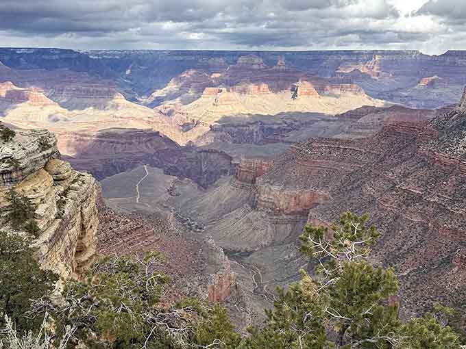 Storm clouds rolling over the canyon turn the whole scene into a painting that no museum could ever contain.