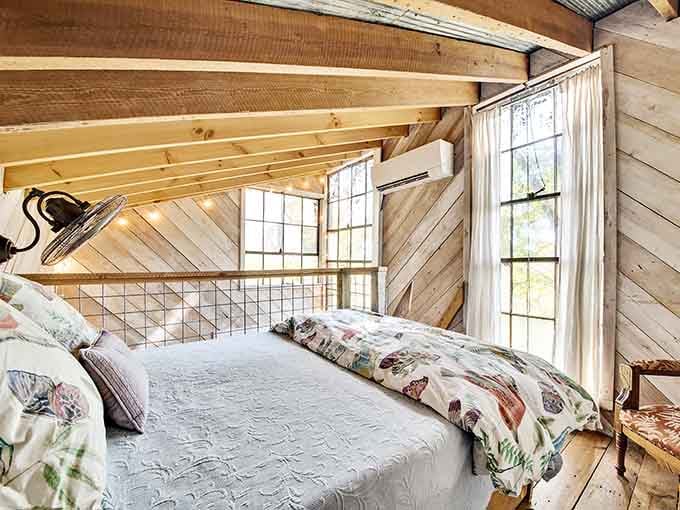 Tucked beneath sloped wooden beams and soft morning light, this sleeping loft makes waking up feel genuinely worth celebrating.