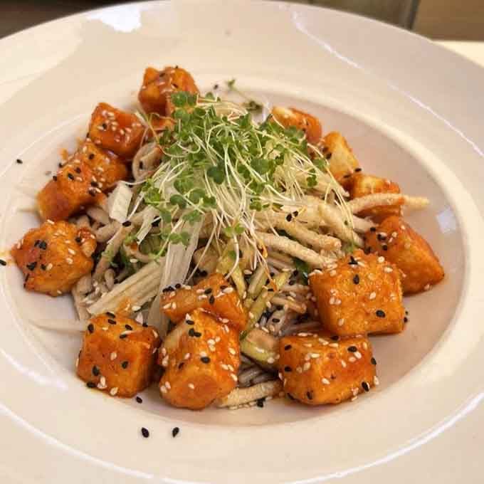 Golden, glazed, and crowned with microgreens, this bowl is proof that Trevor's kitchen takes vegetables just as seriously as everything else.