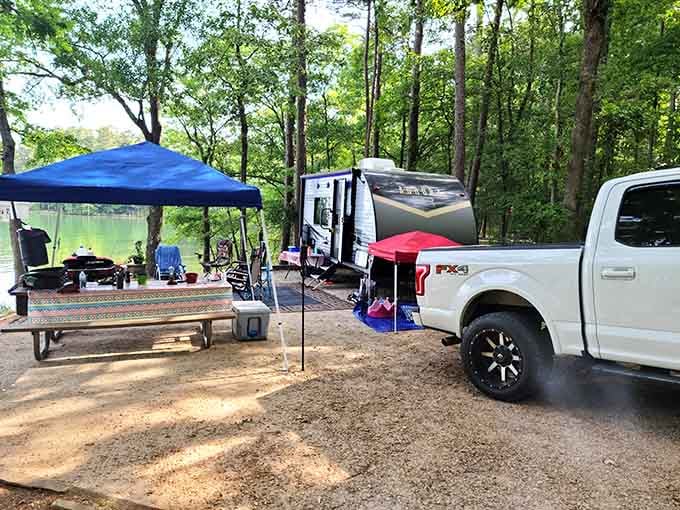 A full campsite setup with canopies, coolers, and enough gear to suggest someone planned this trip very seriously.