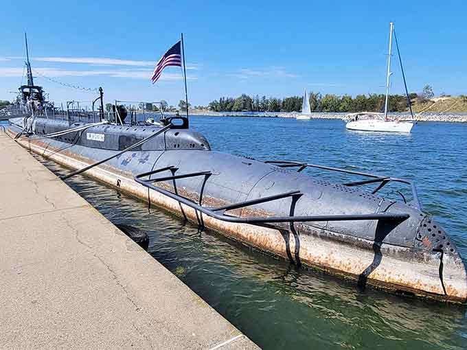 Old Glory flies proudly above a hull that earned every bit of rust through genuine, hard-won Pacific service.