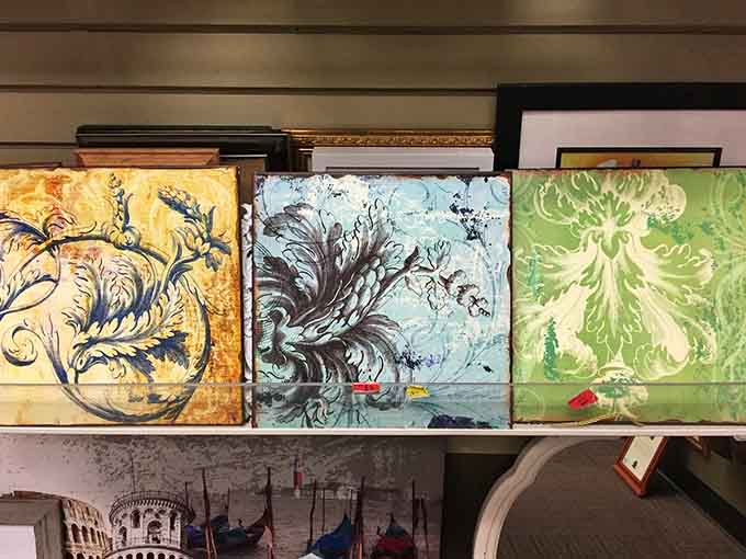 Three bold, colorful canvases sitting on a shelf, proof that great art doesn't always come with a gallery price tag.