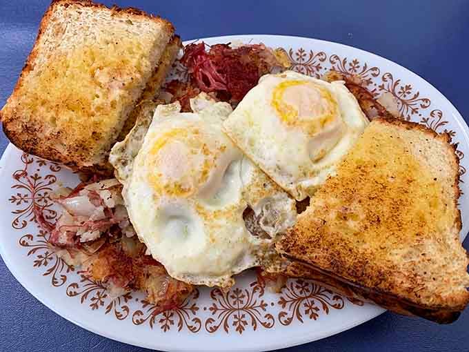 Two sunny-side-up eggs, corned beef hash, and golden toast. This breakfast plate means Michigan mornings are officially handled.