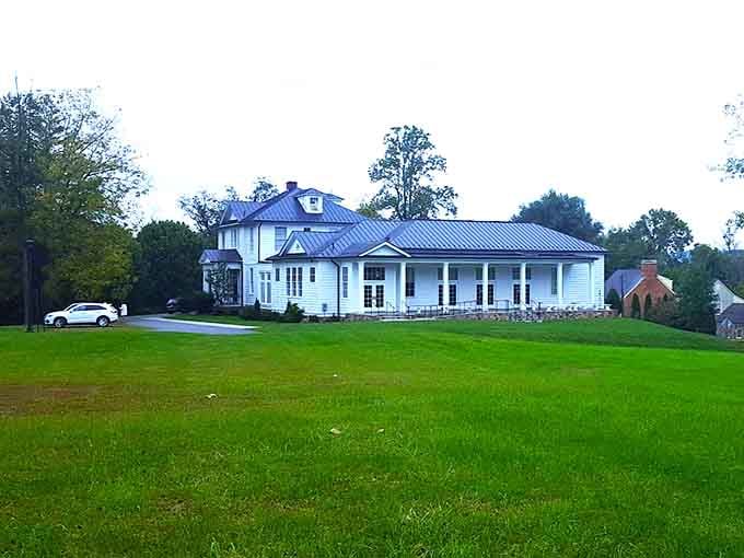 This grand white house sits quietly on its hill, looking like it has seen absolutely everything and judged none of it.