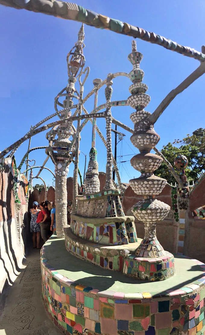 Seashells, bottle glass, and ceramic fragments crowd every surface, turning what was once considered trash into something genuinely breathtaking.
