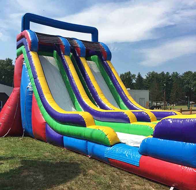 This rainbow-colored water slide towers over the grounds like a beacon of pure, unadulterated joy for kids of all ages.
