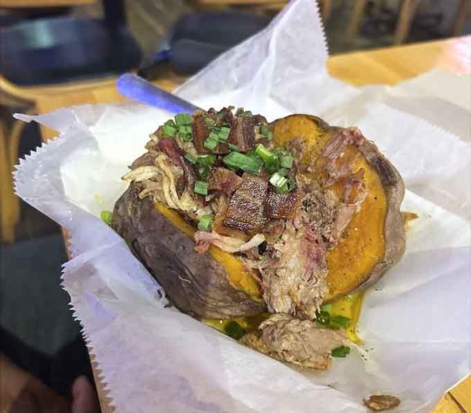 That loaded sweet potato is piled so high with meat, it's practically defying gravity and all known laws of portion control.