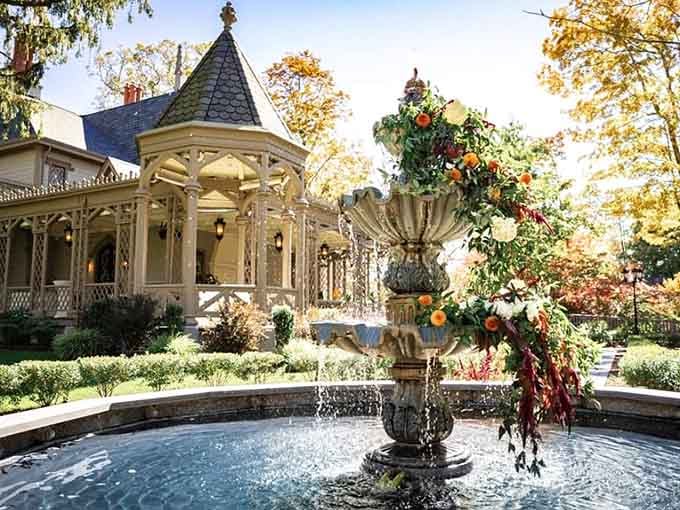 A stone fountain dressed in autumn florals, with the gazebo behind it. Connecticut has been holding out on you.