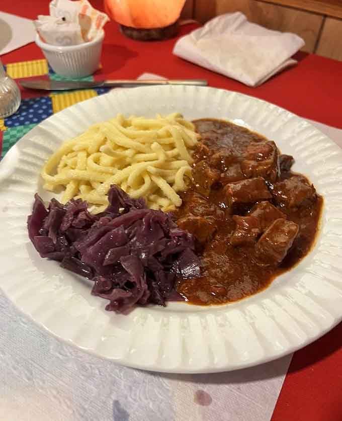 Tender goulash, silky sp&auml;tzle, and braised red cabbage sharing one plate, a trio that belongs together like old friends at dinner.