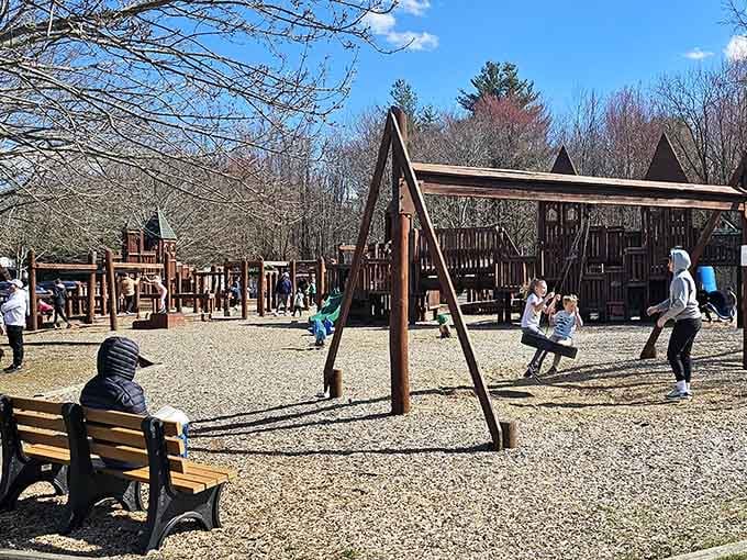 Smart parents know that wooden bench is the best seat in the house for watching swing-set acrobatics unfold.