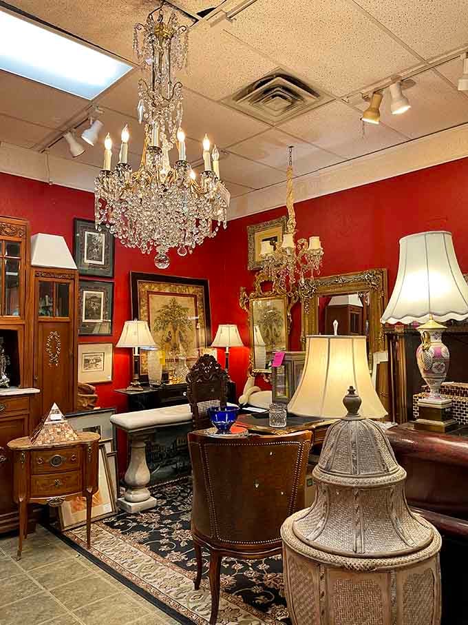 That crystal chandelier hanging against the red wall creates drama worthy of a Hollywood set designer's wildest dreams.