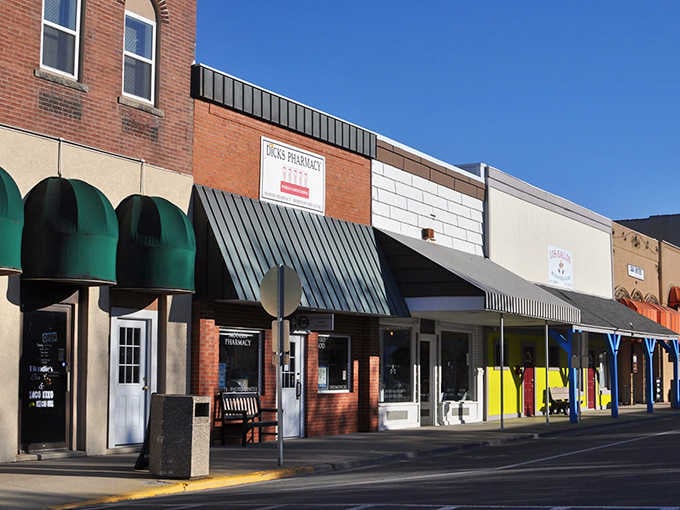 Green awnings and simple storefronts reflect Arthur's no-nonsense approach to commerce, where quality speaks louder than flash.