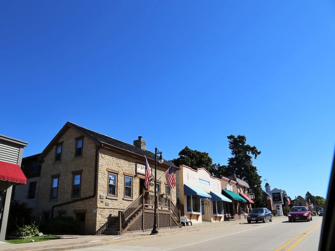 Stone buildings and American flags create a postcard-perfect scene that feels genuinely welcoming, not staged.