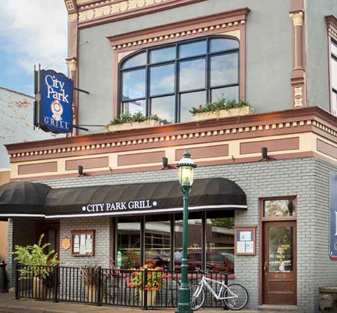 That ornate brick facade and the warm glow of a street lamp make City Park Grill look absolutely irresistible.