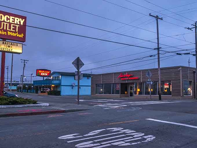 Dusk settles over Crescent City's practical strip, where a Grocery Outlet sign promises bargains every single day.
