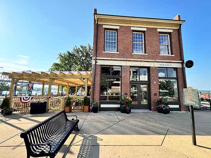 Warm brick, fresh flowers at the entrance, and a pergola patio that practically radiates a perfect summer afternoon.