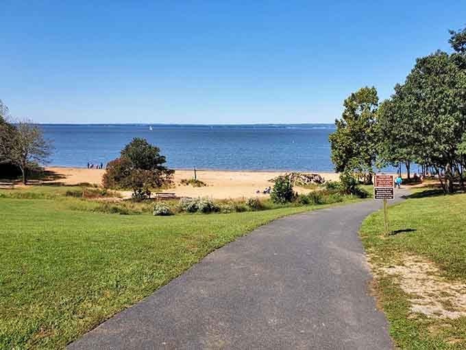 A smooth paved path rolls toward golden sand and sparkling Chesapeake Bay water &mdash; honestly, this looks like a vacation brochure come to life.