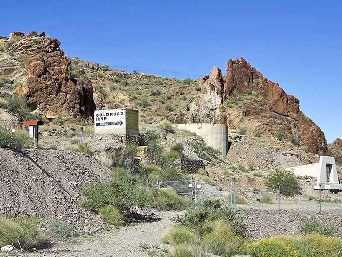 The Gold Road Mine sign says "Do Not Enter," and honestly, those jagged rocks behind it are making the same point louder.