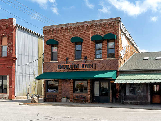 The Dukum Inn's warm brick facade and forest-green awning make it look like exactly the kind of neighborhood spot where everybody eventually becomes a regular.