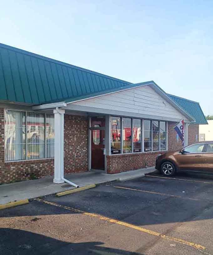 That welcoming red door tucked beneath a green roof says Lulu's Kitchen is ready for you, rain or shine.
