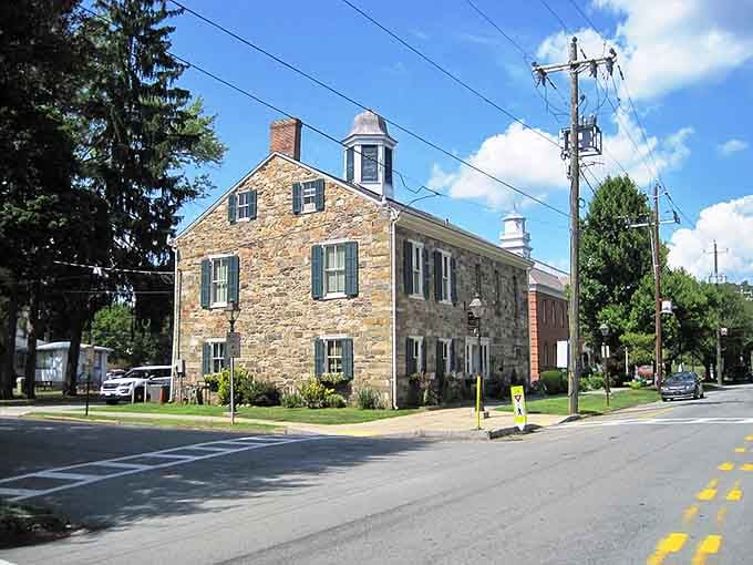 Stone walls and green shutters give this historic building the kind of character modern construction can't replicate.