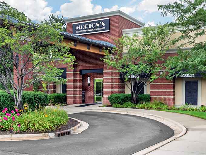 A curved driveway lined with summer blooms leads straight to Morton's door, because even the approach to a great steak should feel like an event.