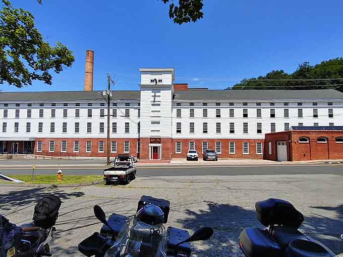Parked bikes out front, brick walls standing tall — this old mill building has serious road-trip credentials.