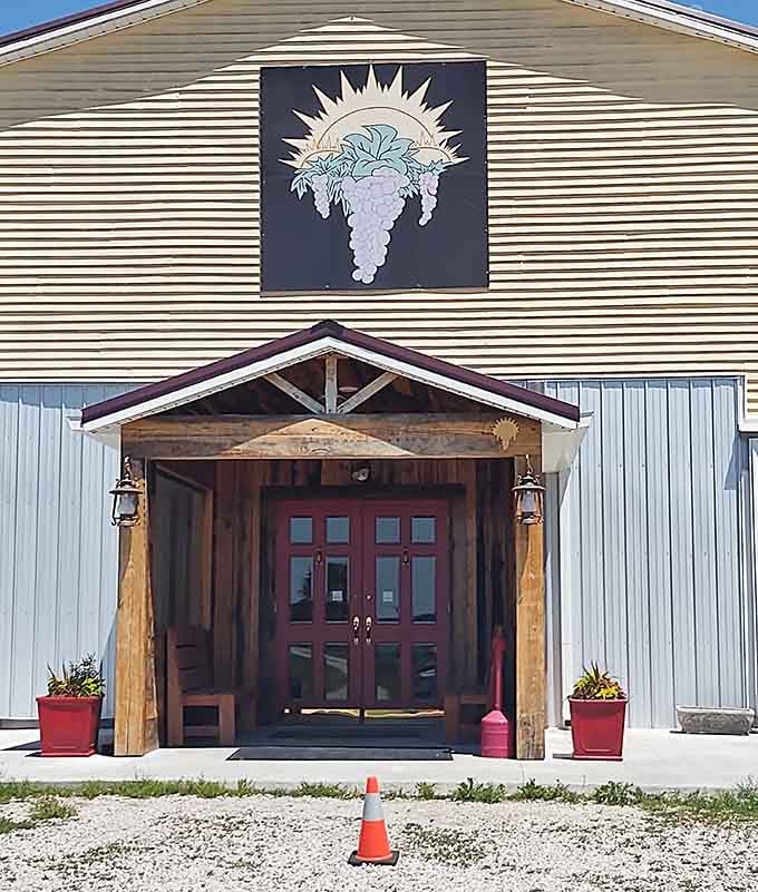 That bold grape cluster logo blazing above rustic wooden doors is basically a neon sign saying "adventure starts here."
