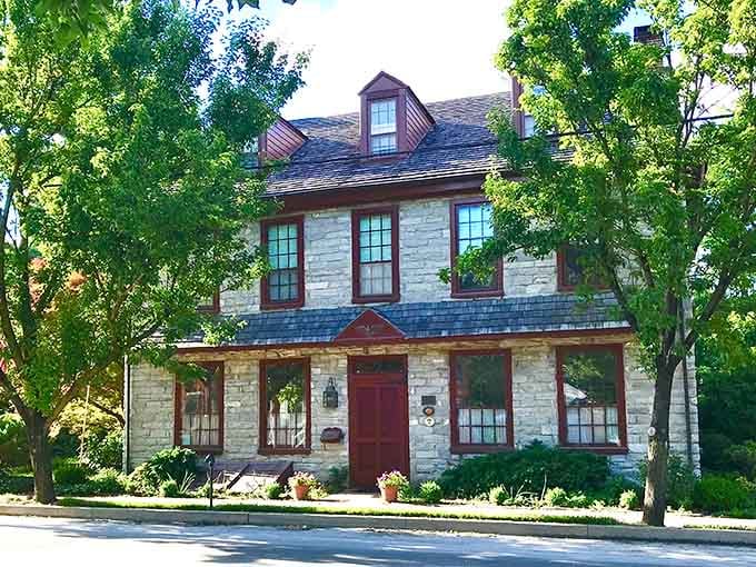 That stone building tucked behind summer green trees in Strasburg has the quiet confidence of a place that knows exactly what it is.