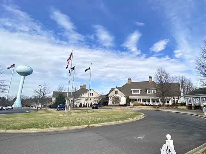 Beautiful clouds stretch across the sky above Tega Cay, where a grand clubhouse and towering water tank welcome you home.