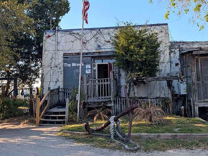A rusty anchor and creeping vines guard the entrance like nature's own bouncer at the world's best seafood spot.