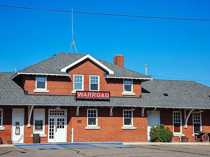 The Warroad depot's bold red sign stands against a perfect blue sky, radiating the pride of a hockey town.