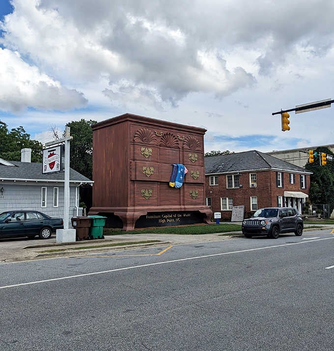 High Point's giant chest of drawers looms over the intersection under dramatic clouds, its oversized socks dangling with zero apologies.