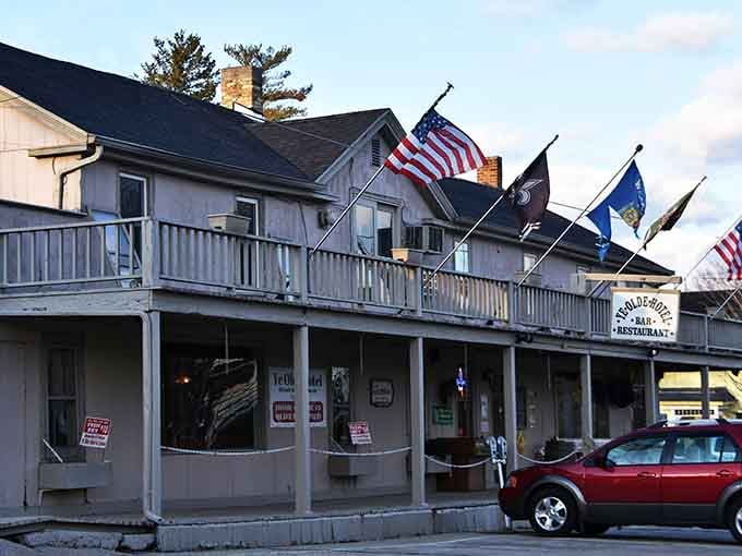 Four flags flying proudly above that covered porch make Ye Olde Hotel look like the neighborhood's most patriotic gathering spot.