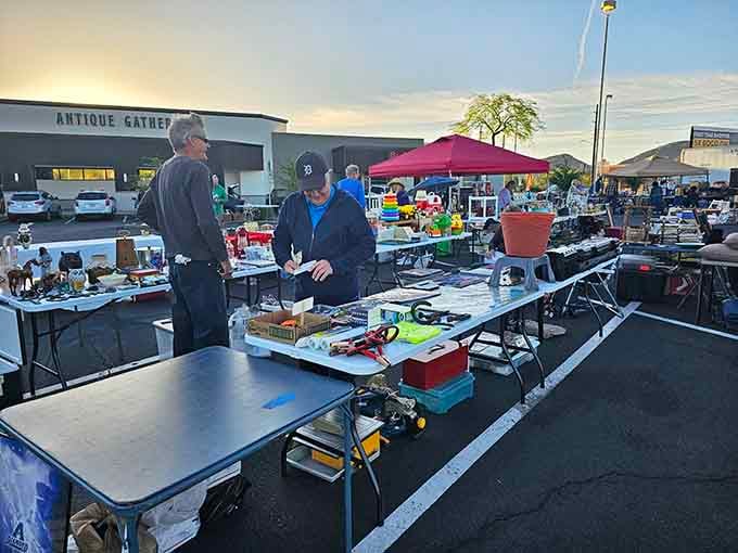 The outdoor market buzzes with early morning energy as vendors display their finds under the wide Arizona sky.
