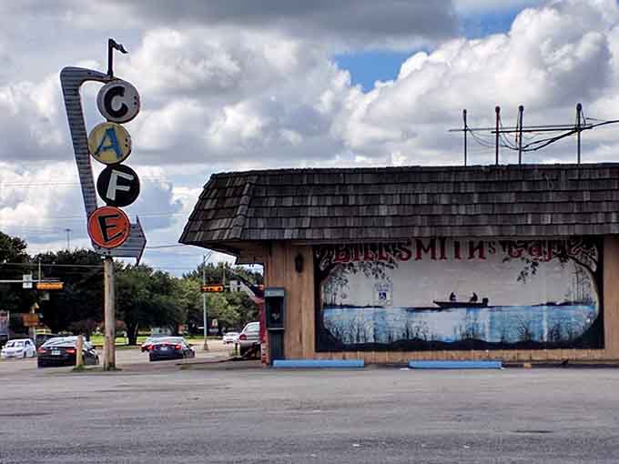 The painted lake mural stretching across the side wall turns this corner cafe into a full-on Texas roadside landmark worth stopping for.