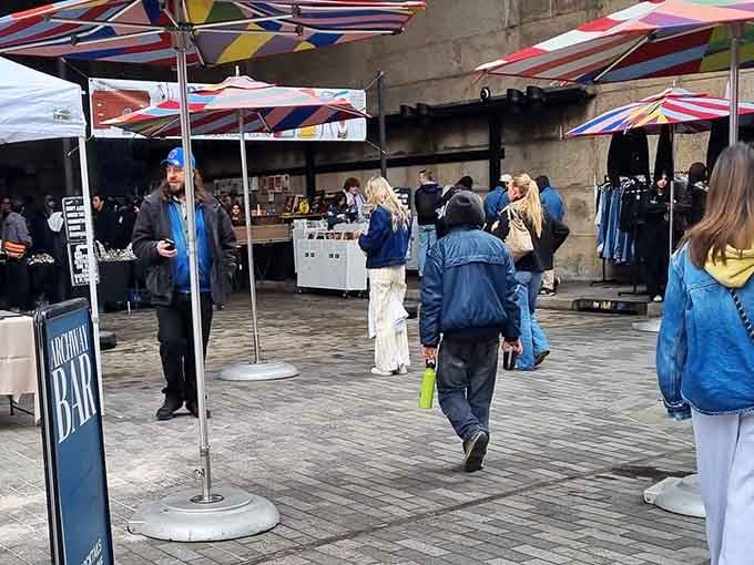 Colorful striped umbrellas dot the Brooklyn Flea's outdoor plaza, where browsers and bargains mix effortlessly together.