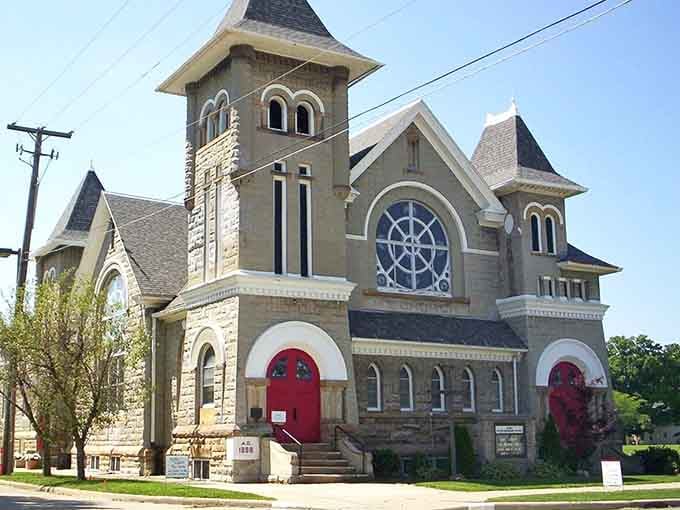 Red doors, a stone tower, and a stunning rose window make this Crestline church look like it belongs in a European travel guide.