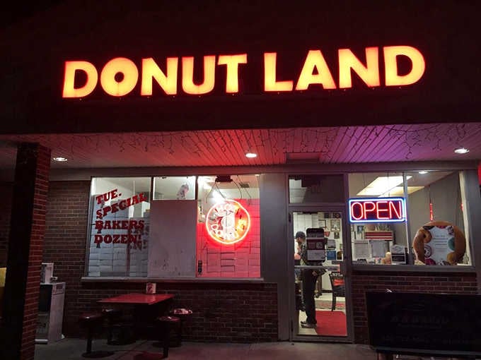After dark, Donut Land's glowing sign and neon "Open" light cut through the night like a delicious lighthouse beacon.