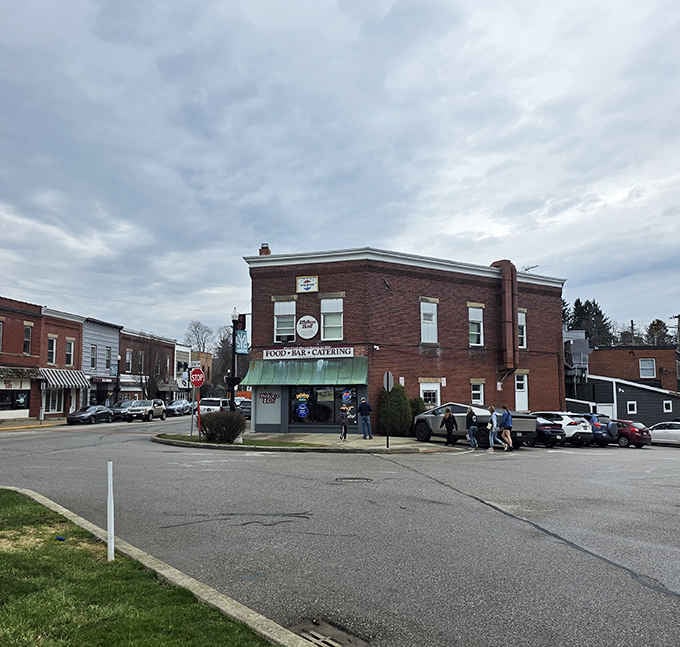 Corner lot, cloudy skies, and a brick building that anchors downtown Edinboro like it's been holding the whole town together for decades.