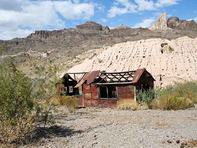 A collapsed tin roof, crumbling wooden walls, and mountains so dramatic they look painted, Gold Road doesn't need words to tell its story.