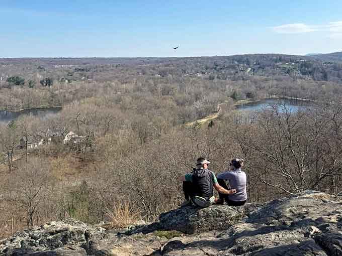 Two friends perched on ancient rock, proving the best views are always better when shared with someone special.