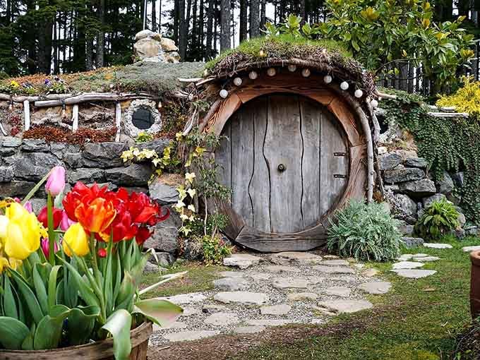 Bright tulips lead the eye straight to that weathered wooden door, where whimsy meets the Pacific Northwest perfectly.